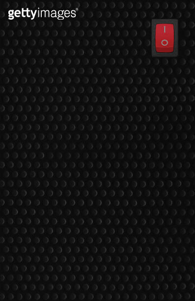 Red rectangle rocker power switch in on position, black abstract dot ...