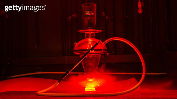 Magic hookah smoke with red lights. Design glass hookah with metal ...