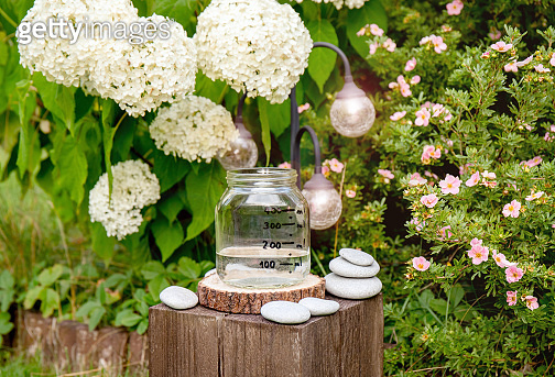Handmade rain water gauge made of glass jar, measuring rain in home ...
