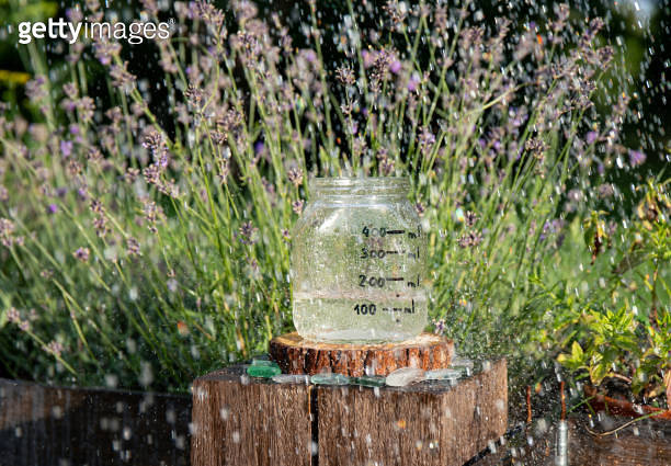 Handmade rain water gauge made of glass jar, measuring rain in home ...