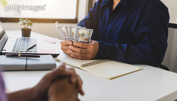 The young man waited to receive salary or wages from the boss ...