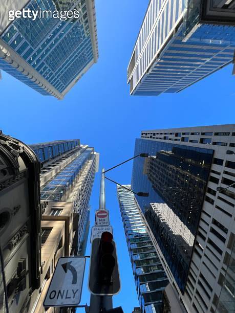 Looking up at tall buildings 이미지 (1397618196) - 게티이미지뱅크