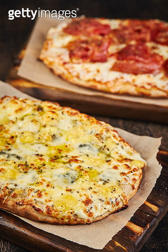 Two Roman-style pizzas with cheese and bacon. Roman square pizza or ...