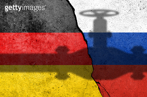 Flag of Germany and Russia painted on a concrete wall with gas pipe ...