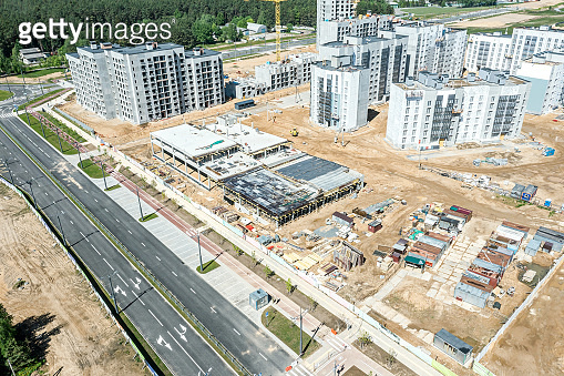 aerial view of construction site in residential area with new apartment ...