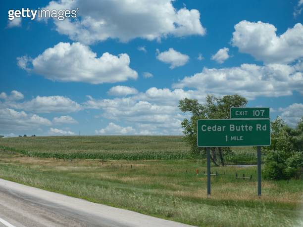Roadside sign with directions to the exit for Cedar Butte in South ...