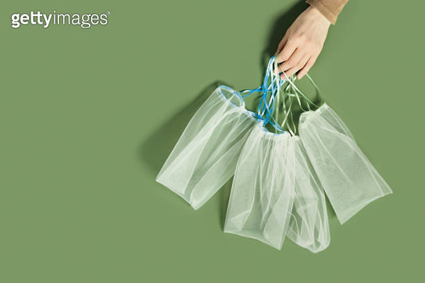 Hand holding reusable produce bags, diy from textile, reusable ...