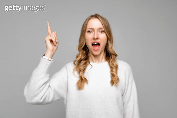 Got an idea. Excited attractive beautiful young woman, raising index ...
