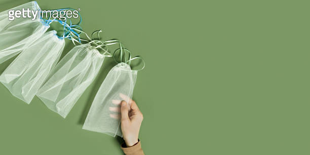 Hand holding reusable produce bags, diy from textile, reusable ...