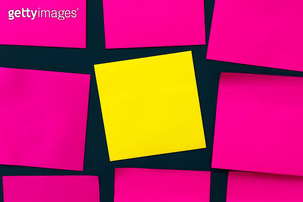 A yellow sticky sticker is the center of attention among pink note ...