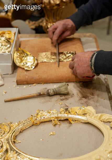 Application of gold leaf to a frame. Gilding process technique ...