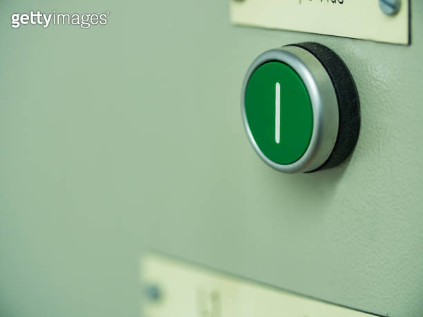 Green push button on a switchboard to control electricity power for an ...