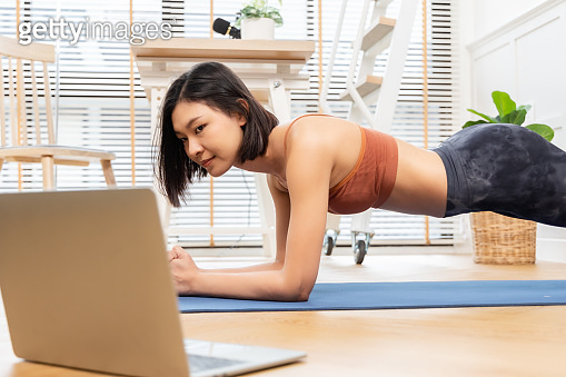 Young Asian woman doing yoga stretching yoga at home.Happy people stay home, doing aerobic ...