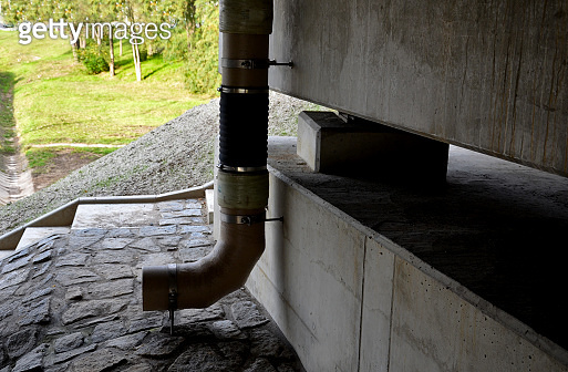 freeway bridge drainage. A sound-absorbing wall with holes lets water ...
