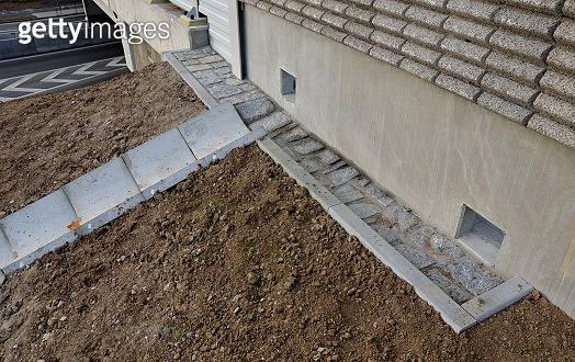 freeway bridge drainage. A sound-absorbing wall with holes lets water ...