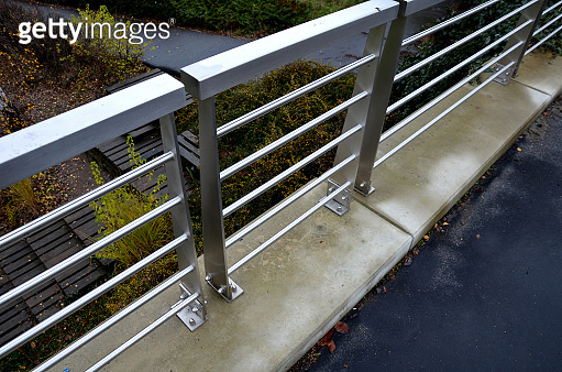 stainless steel railing on the concrete wall of the roof parking lot ...