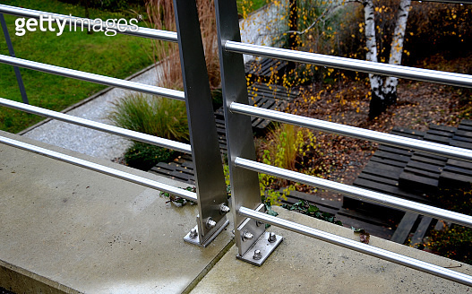 stainless steel railing on the concrete wall of the roof parking lot ...