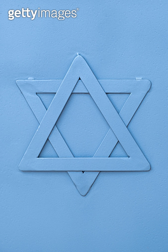 Metal Star of David (Magen David) Jewish symbol at blue fence metal ...
