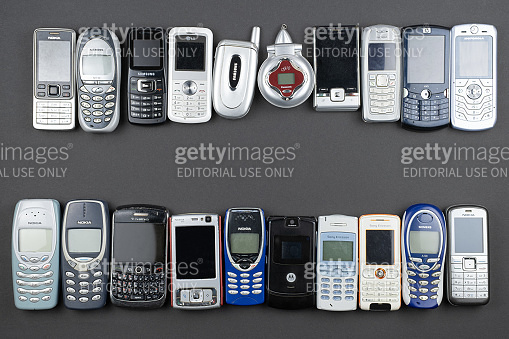 A lot of old used mobile phones with keyboards, Various brands. Many ...