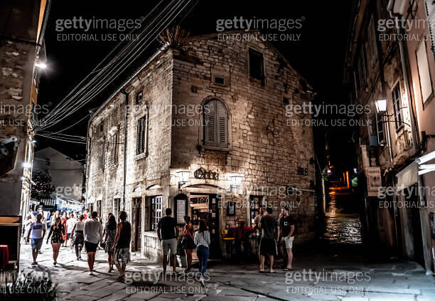 Tourists stroll through narrow streets of Pula in Croatia in the ...