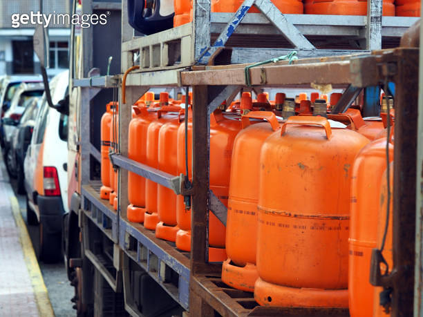 LPG cylinders. Orange bottles with butane. Truck delivered propane ...