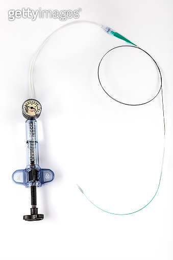 A balloon inflation device used in angioplasty procedure. Mesh metal ...