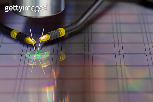 Close up of examining a sample of microchip transistor with probe ...