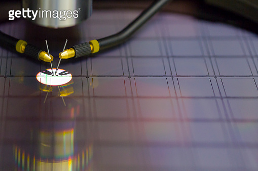 Close up of examining a sample of microchip transistor with probe ...