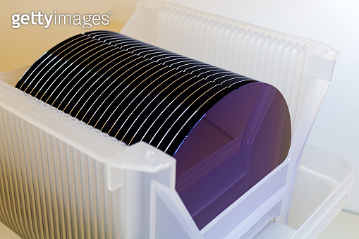 Silicon Wafers in white plastic holder box on a table- A wafer is a ...