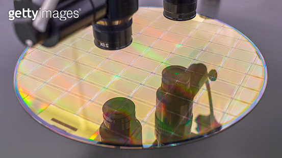 Close up of silicon wafer with microchips on machine process examining ...