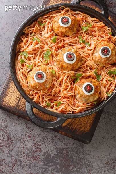 Scary tasty Halloween food of meatballs with monster eyes and spaghetti ...