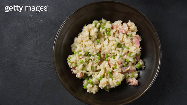 Classic italian risotto with peas, cheese parmesan, prosciutto. Risi e ...