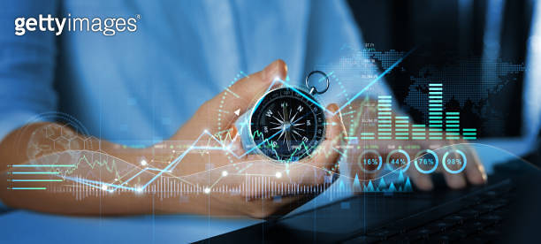 Business person using navigation compass with digital graphics for the ...