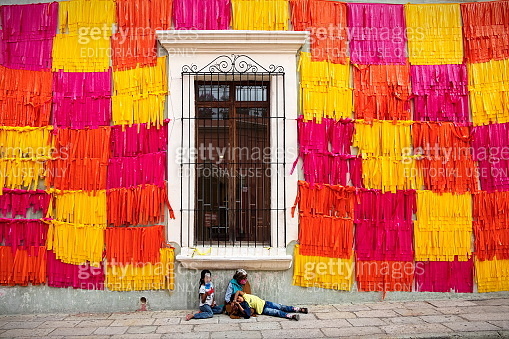 At the streets of Oaxaca, poor Mexican family is lying on the pavement ...