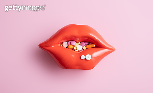 Red lips full of tablets and pills on pink background. Creative medical ...
