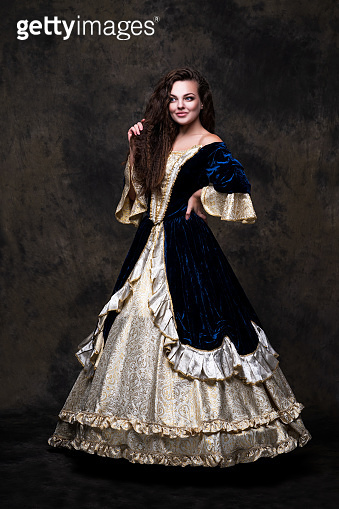 Happy beautiful woman in renaissance royal dress on abstract dark ...