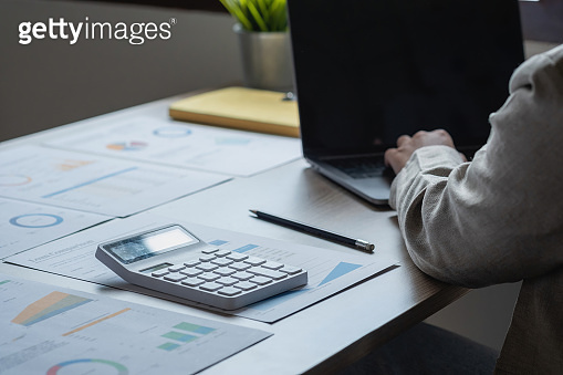Businesswoman presenting profit data with graphs to her supervisor via ...