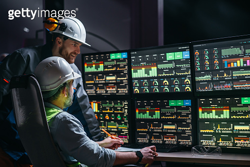 Head engineer and factory operator following product process on factory ...