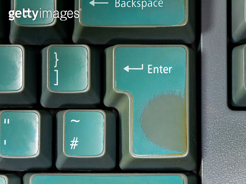 Simple worn faded enter key on an old computer desktop PC keyboard, top ...