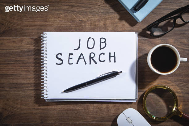 Job Search text on notepad with a magnifying glass, pen and other ...