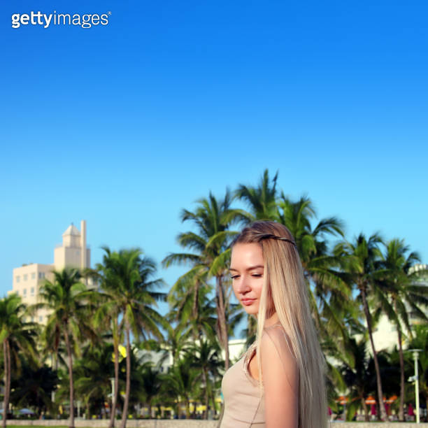 Outdoor portrait of beautiful young blond woman at South Beach, Miami ...