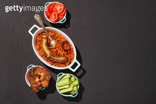 Jollof rice with fried banana, baked chicken. Rice with tomatoes ...