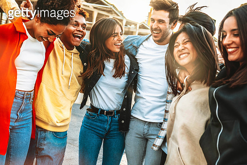 Happy multiracial young people celebrating party together outside ...