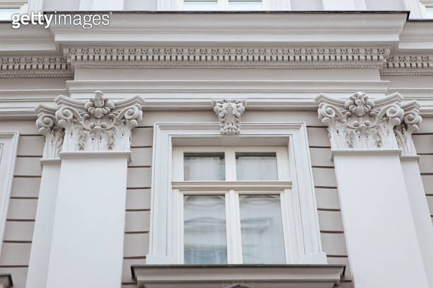 Window with wooden frame. Neoclassical building with a complex ...