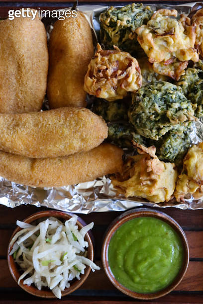 Full frame image of wooden tray of homemade green chilli fritters ...