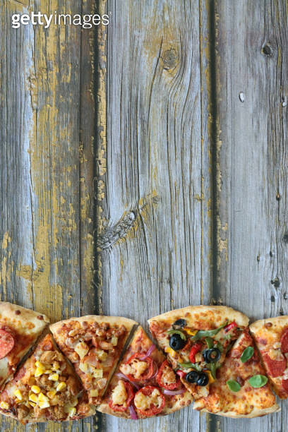 Image of border of pizza slices with various toppings including ...