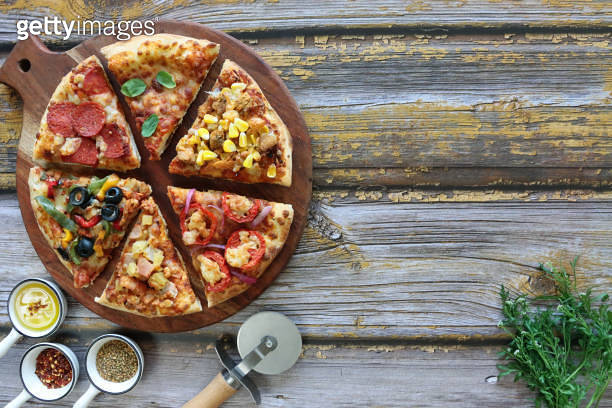Image of pizza slices with various toppings including Hawaiian pizza ...