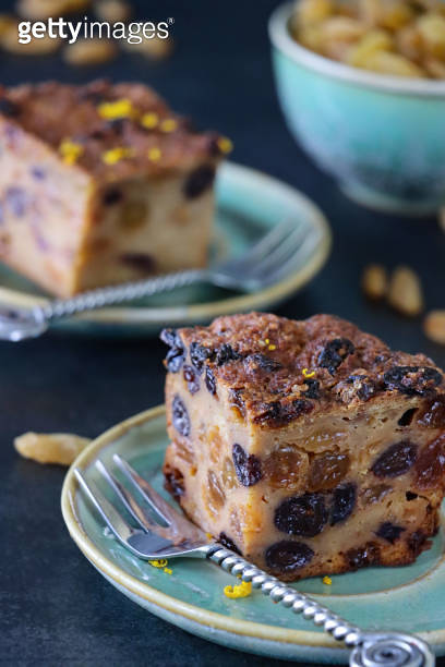 Close-up image of sliced, squares of homemade bread pudding, topped ...