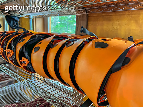 Row of helmets ready for use at a high ropes and climbing course ...