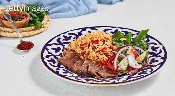 Traditional uzbek food - plov with beef. Eastern cuisine - pilaf with ...